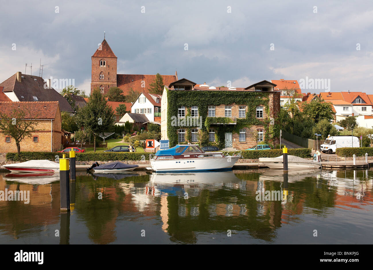 A port and a church by the river Elde, Plau am See, Germany Stock Photo ...