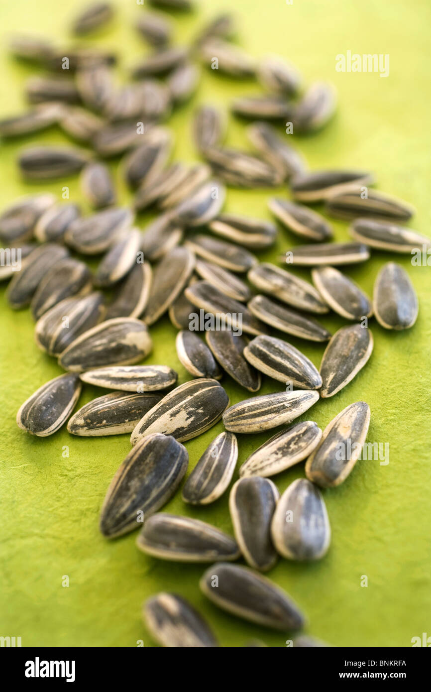 Sunflower seeds on a green background Stock Photo - Alamy