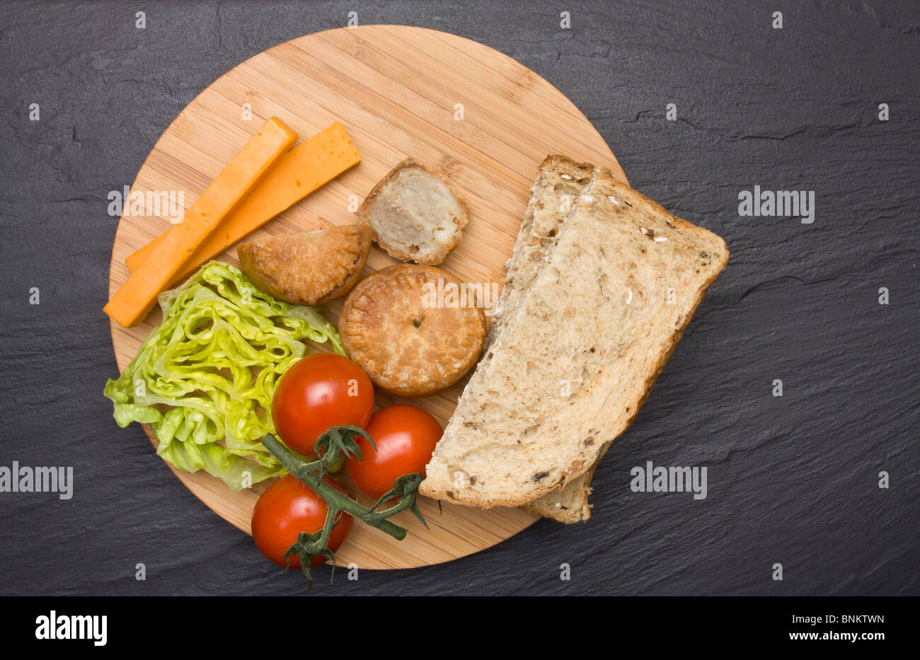 Traditional English Ploughmans Lunch of cheese, bread, tomato, lettuce ...