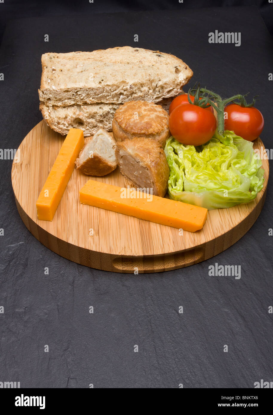 Traditional English Ploughmans Lunch of cheese, bread, tomato, lettuce ...