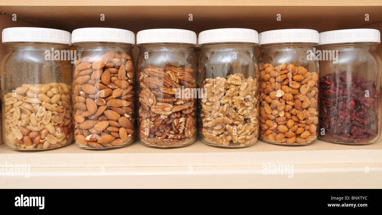 Healthy Nuts in Glass Jars sitting on a shelf Stock Photo - Alamy