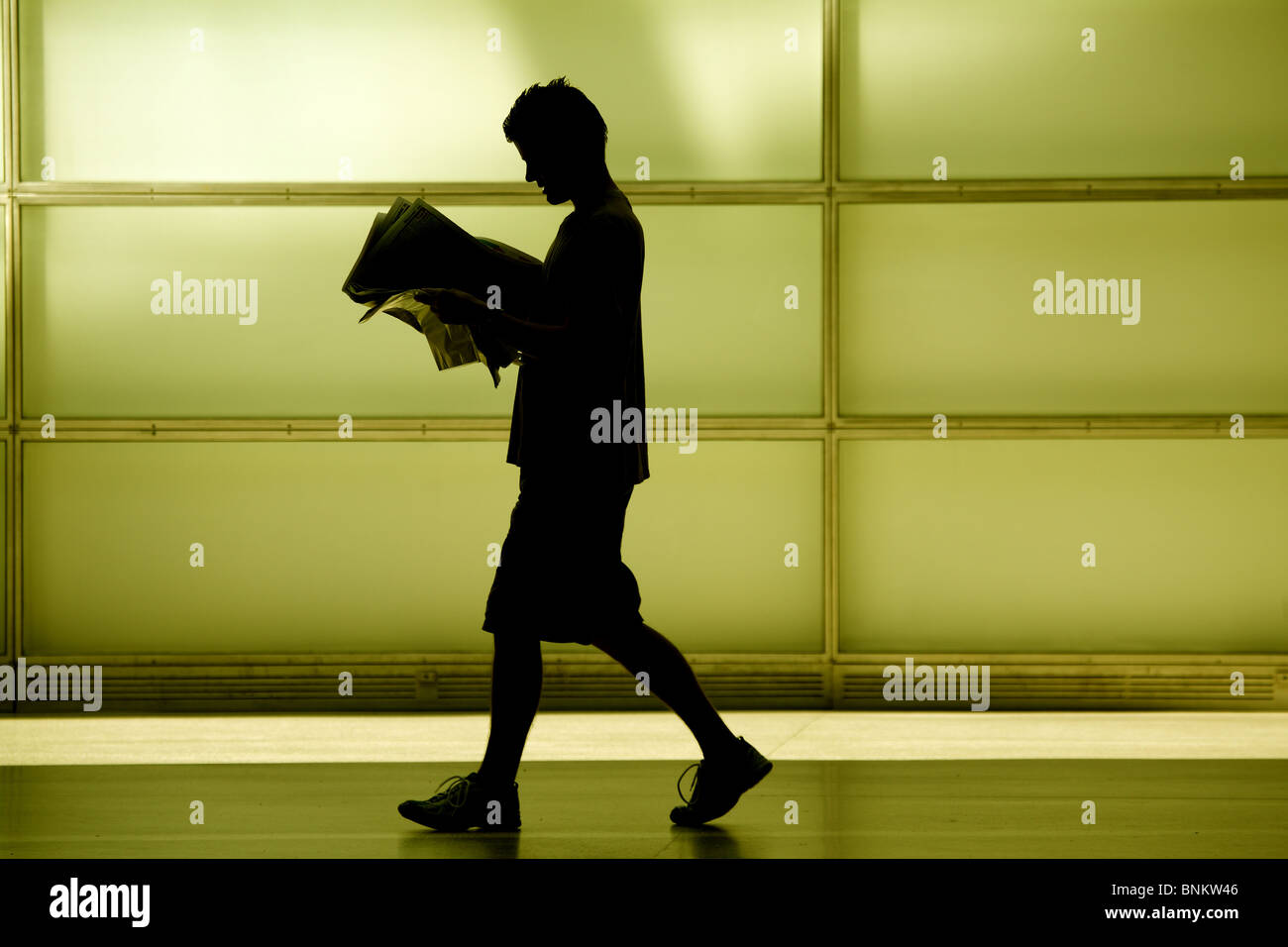 Young Man Walking Reading Newspaper High Resolution Stock Photography ...