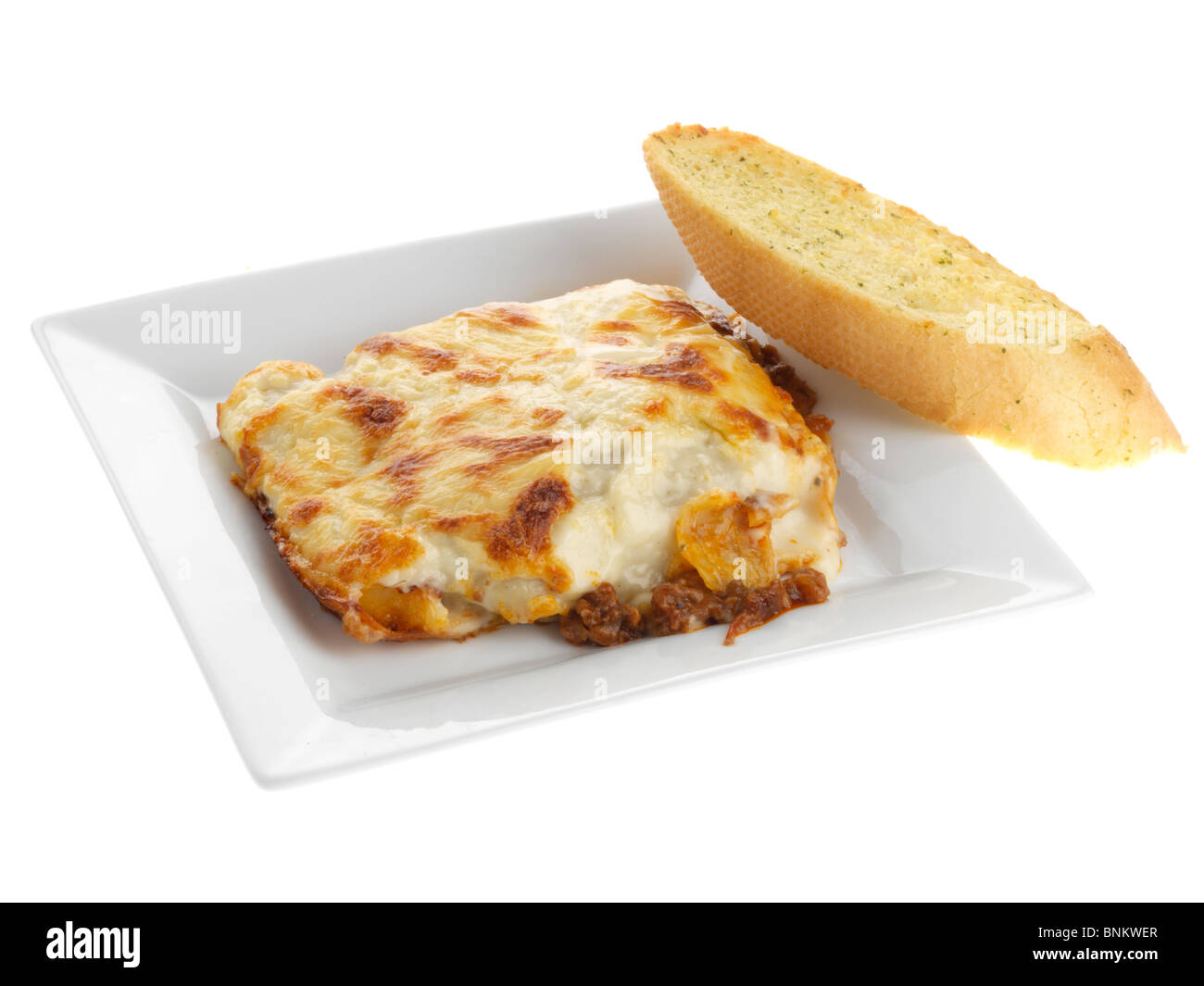 Portion of Lasagne with Garlic Bread Stock Photo - Alamy