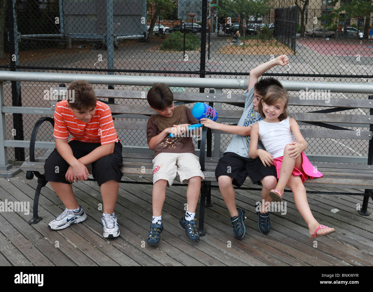 playing kids on bench Stock Photo - Alamy