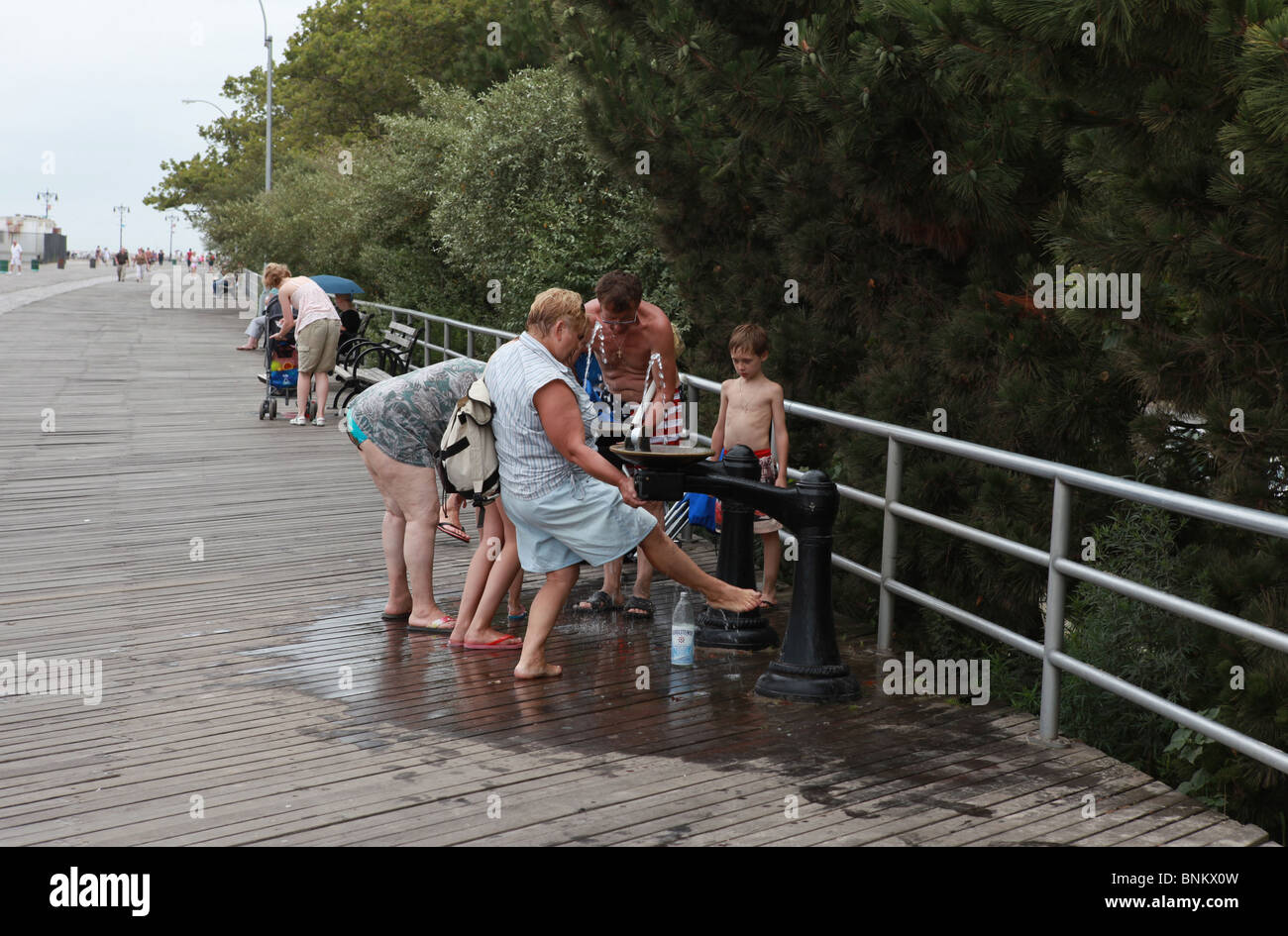 Washing sand off at beach hi-res stock photography and images - Alamy