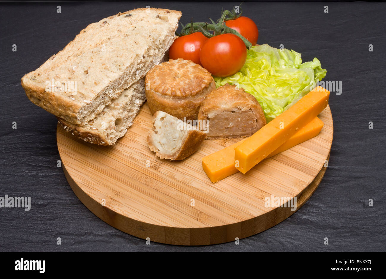 Traditional English Ploughmans Lunch of cheese, bread, tomato, lettuce ...
