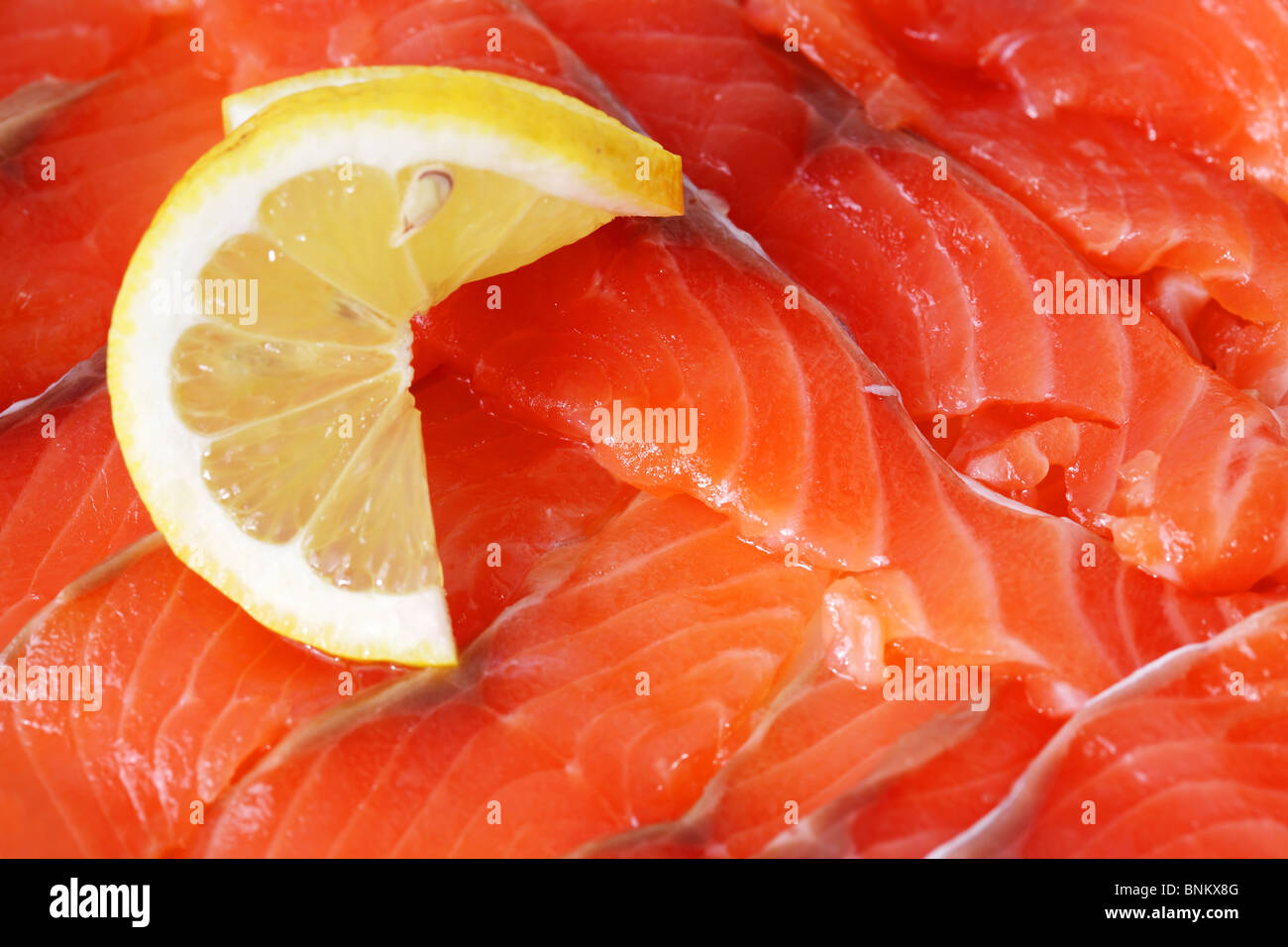 Slices of red fish and lemon Stock Photo - Alamy