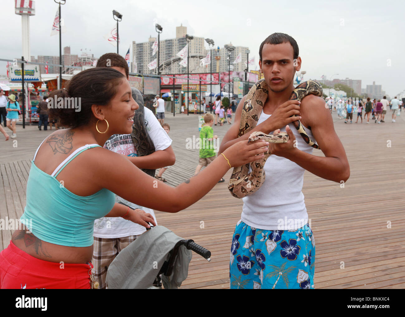woman petting snake Coney Island NY Stock Photo - Alamy