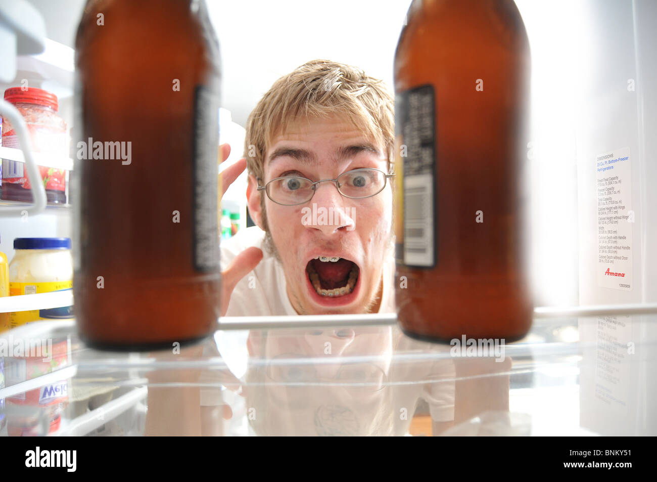 Man screaming at beer bottles in his refrigeration Stock Photo - Alamy
