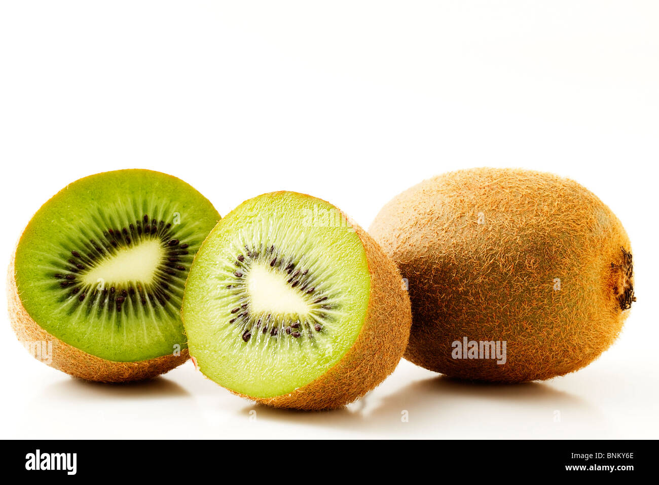 one kiwifruit and two half kiwis isolated on white background Stock ...