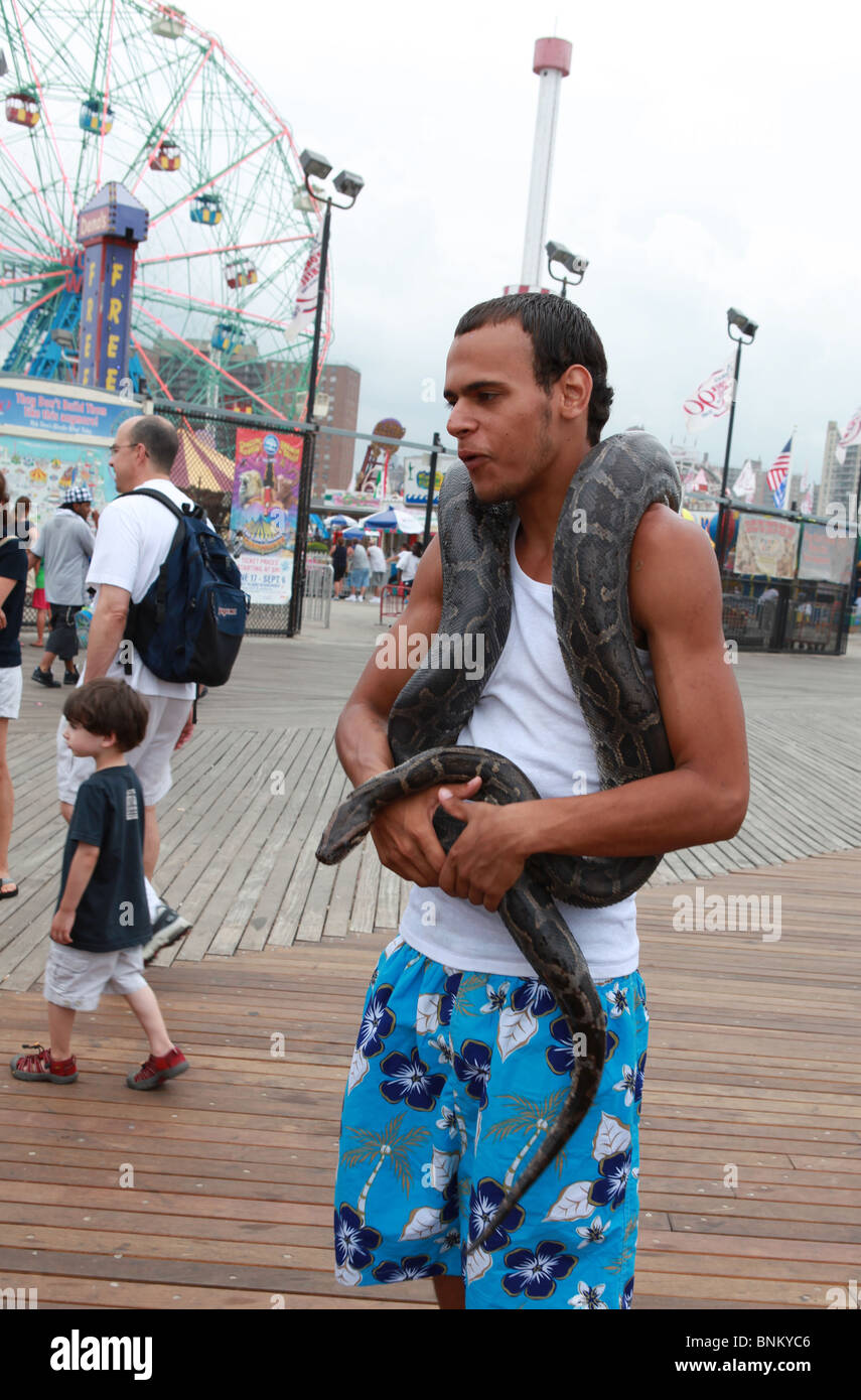 Man with snake on Coney Island boardwalk Stock Photo - Alamy