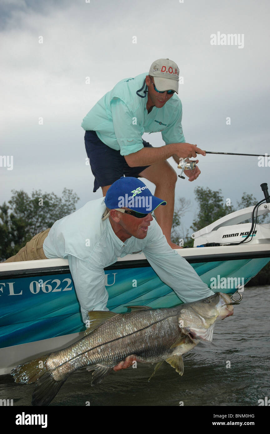 A guide helps land an inshore angler's giant snook caught in the Indian ...
