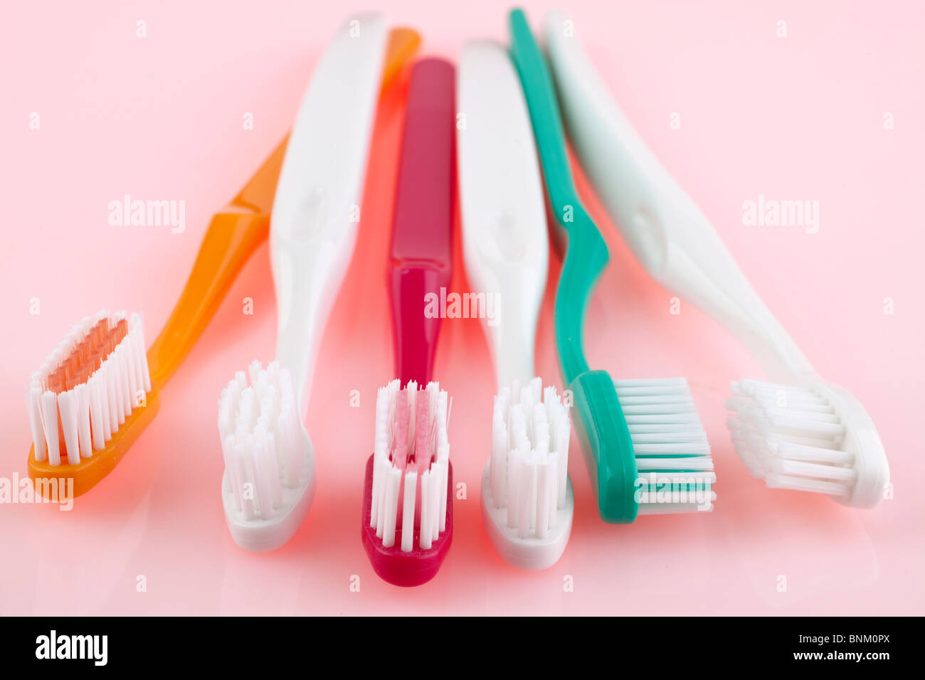 Six coloured toothbrushes Stock Photo - Alamy