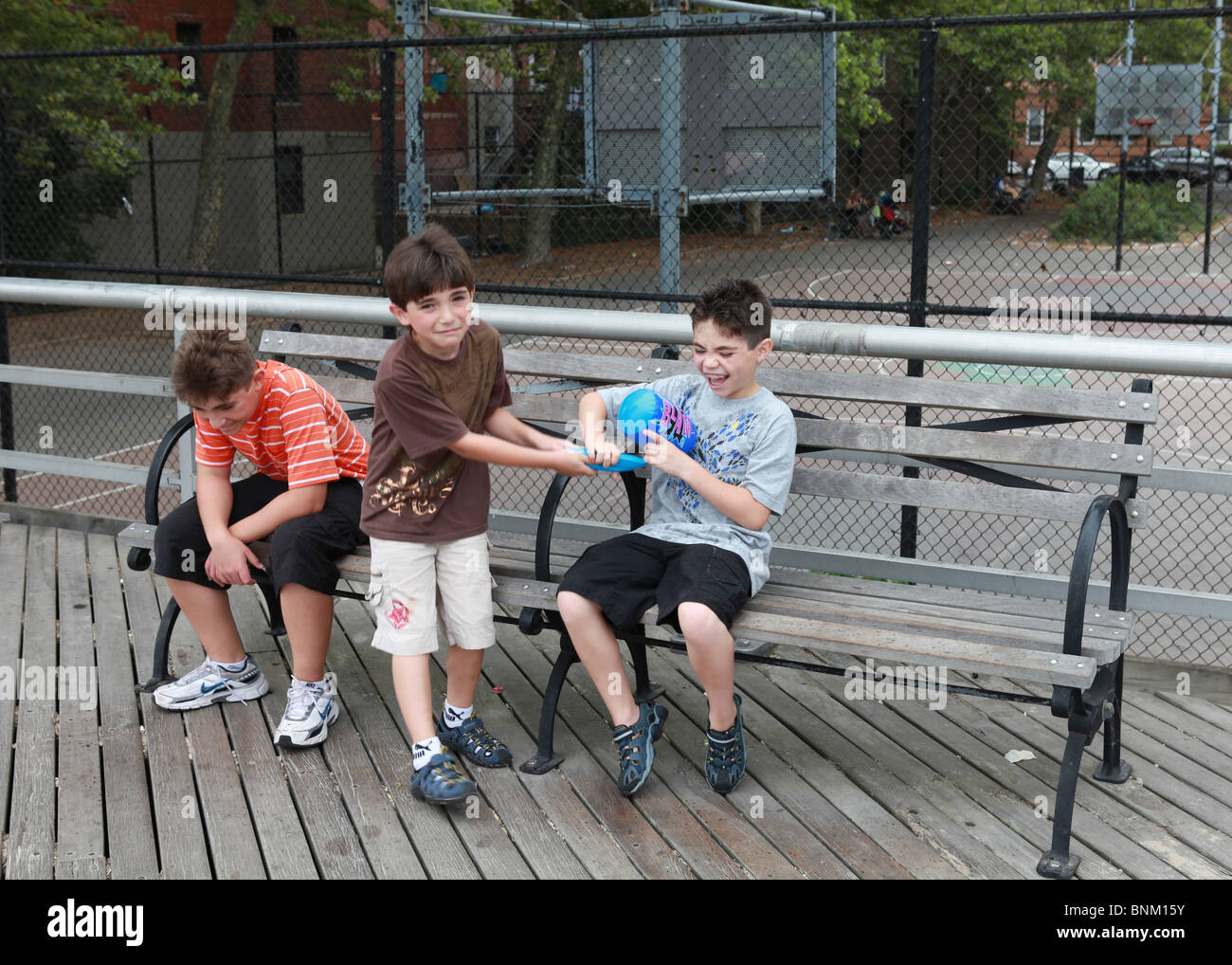 playing boys on bench Stock Photo - Alamy