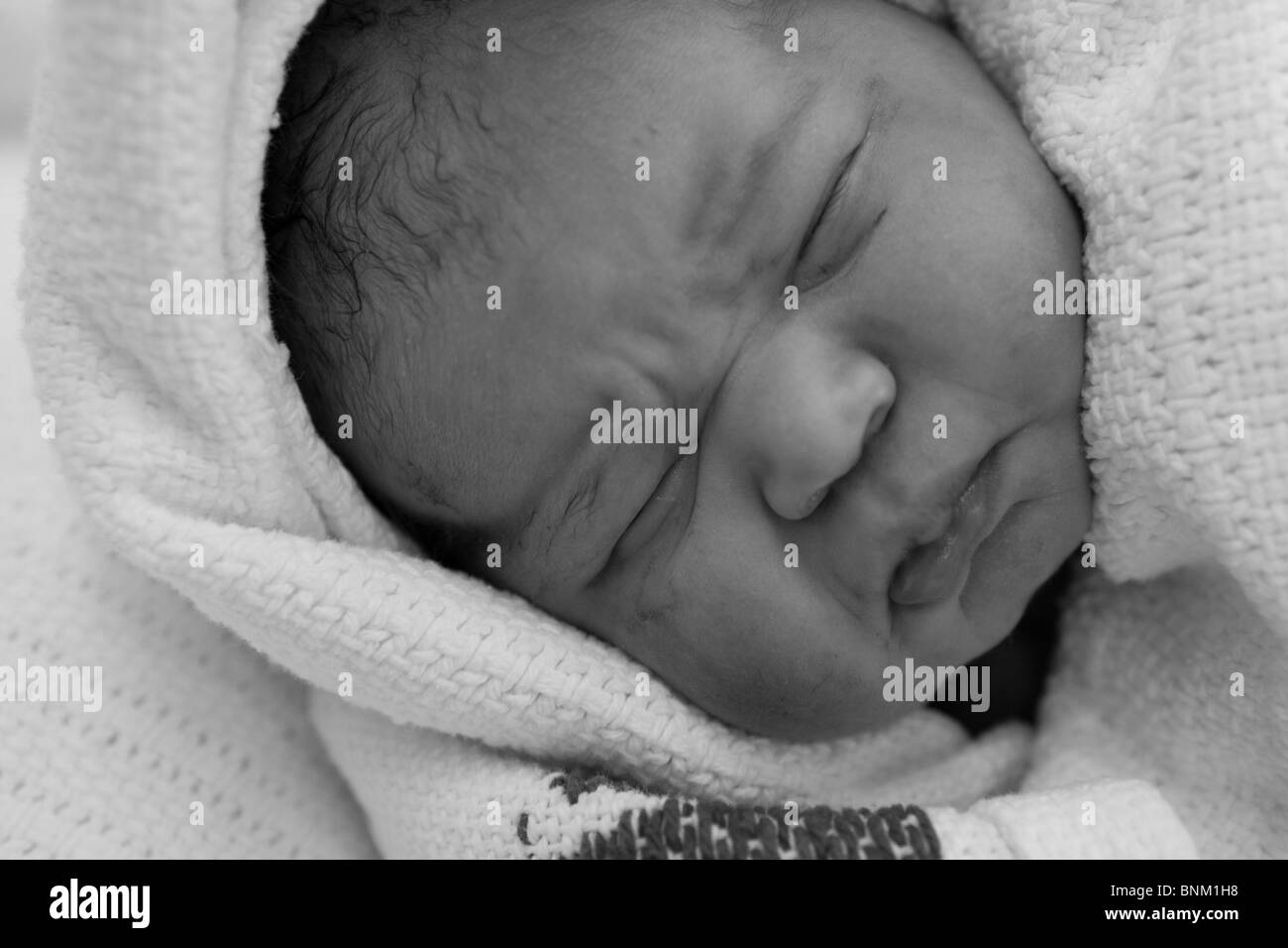 Swaddled new born baby Stock Photo - Alamy
