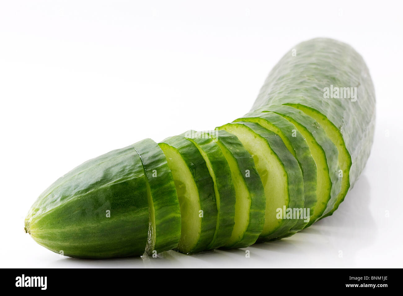 one chopped cucumber isolated on white background Stock Photo - Alamy