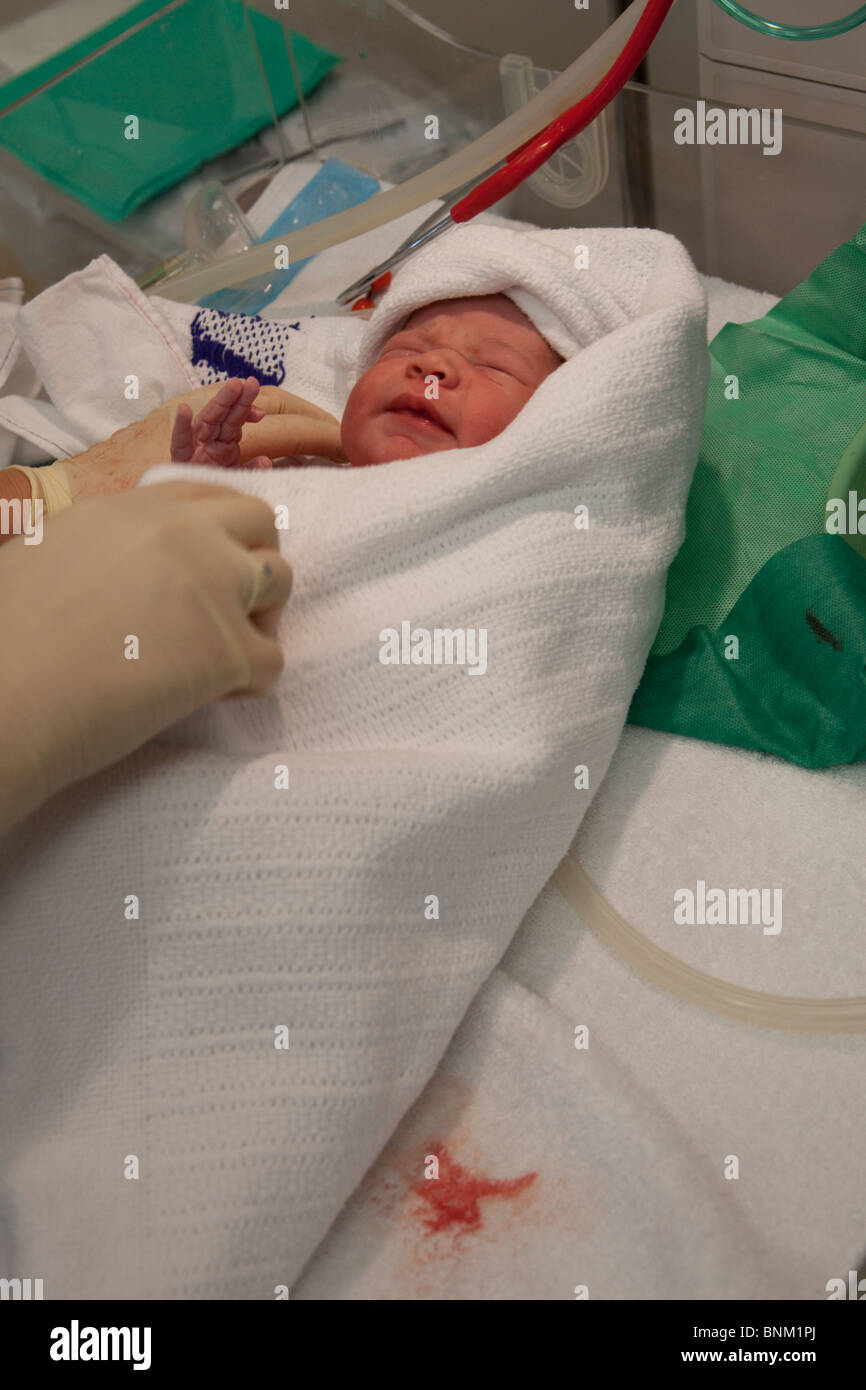 Newborn baby being examined by medical staff Stock Photo - Alamy