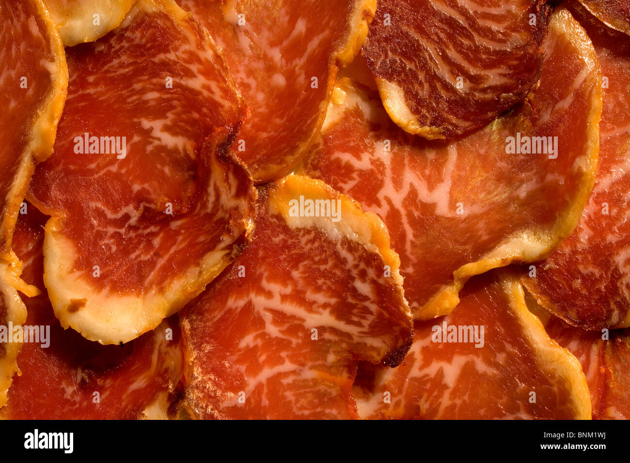 Cured loin slices made from Spanish Iberian pigs sit on a plate in ...