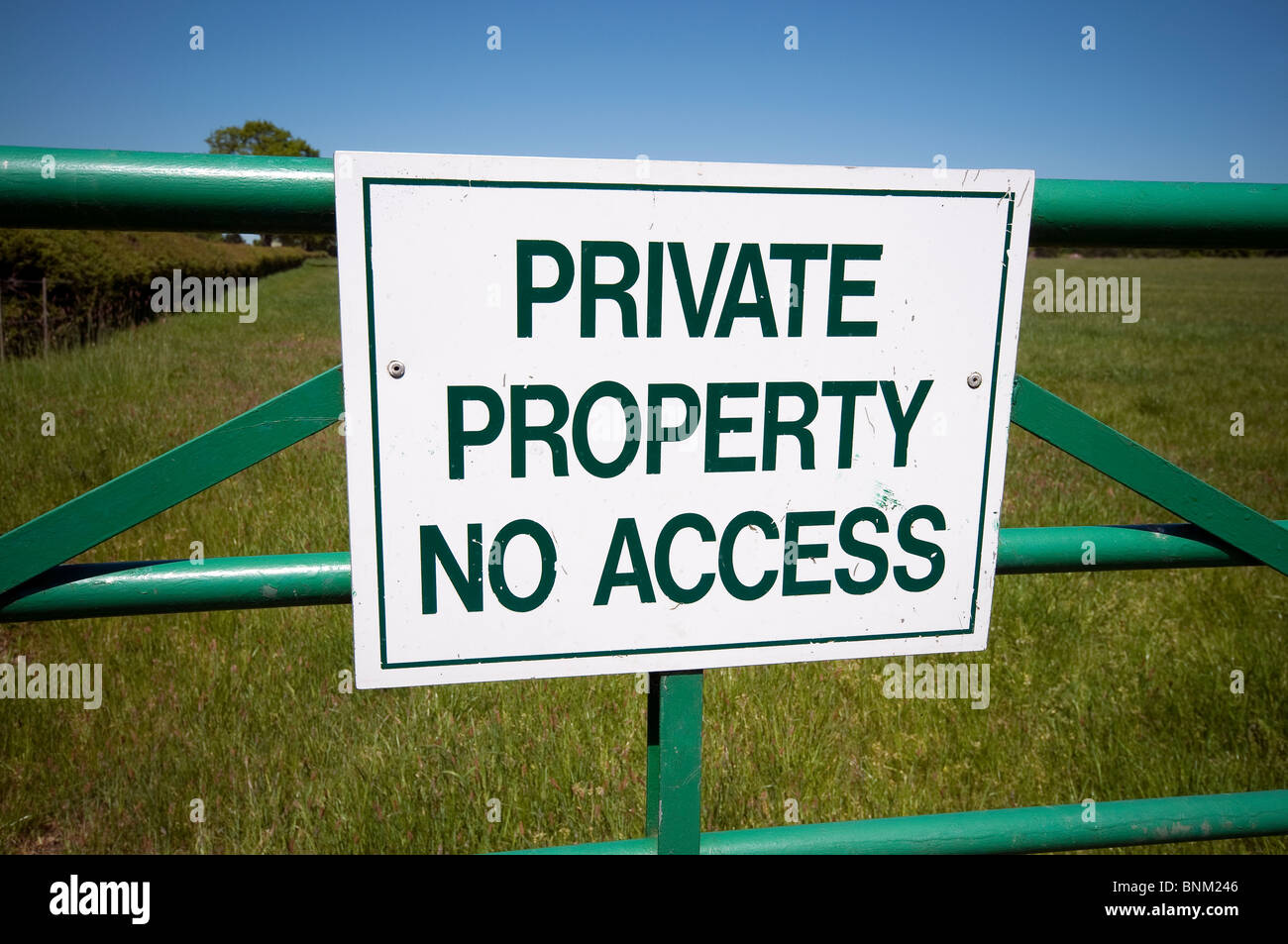 Private property no access sign on green metal gate Stock Photo - Alamy