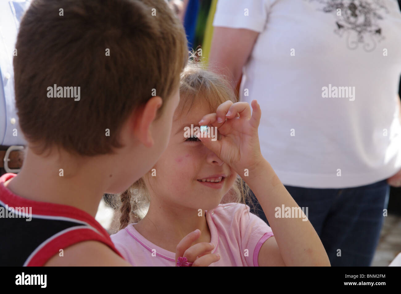 Child is looking through a glass glittering stone Stock Photo - Alamy