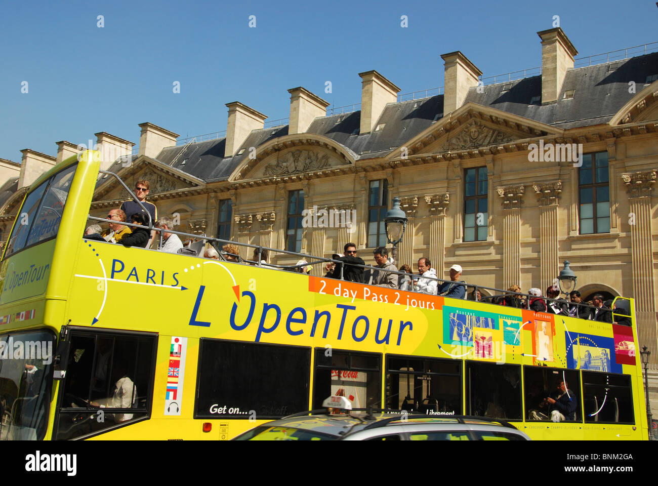 sightseeing bus at Louvre Paris France Stock Photo - Alamy