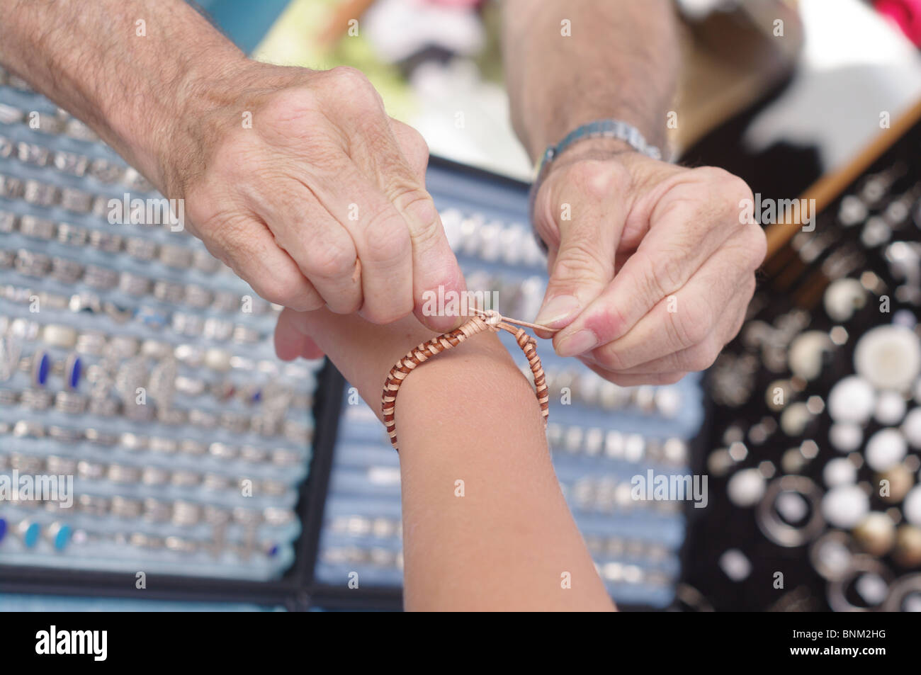 someone is fixing a friendship bracelet Stock Photo - Alamy