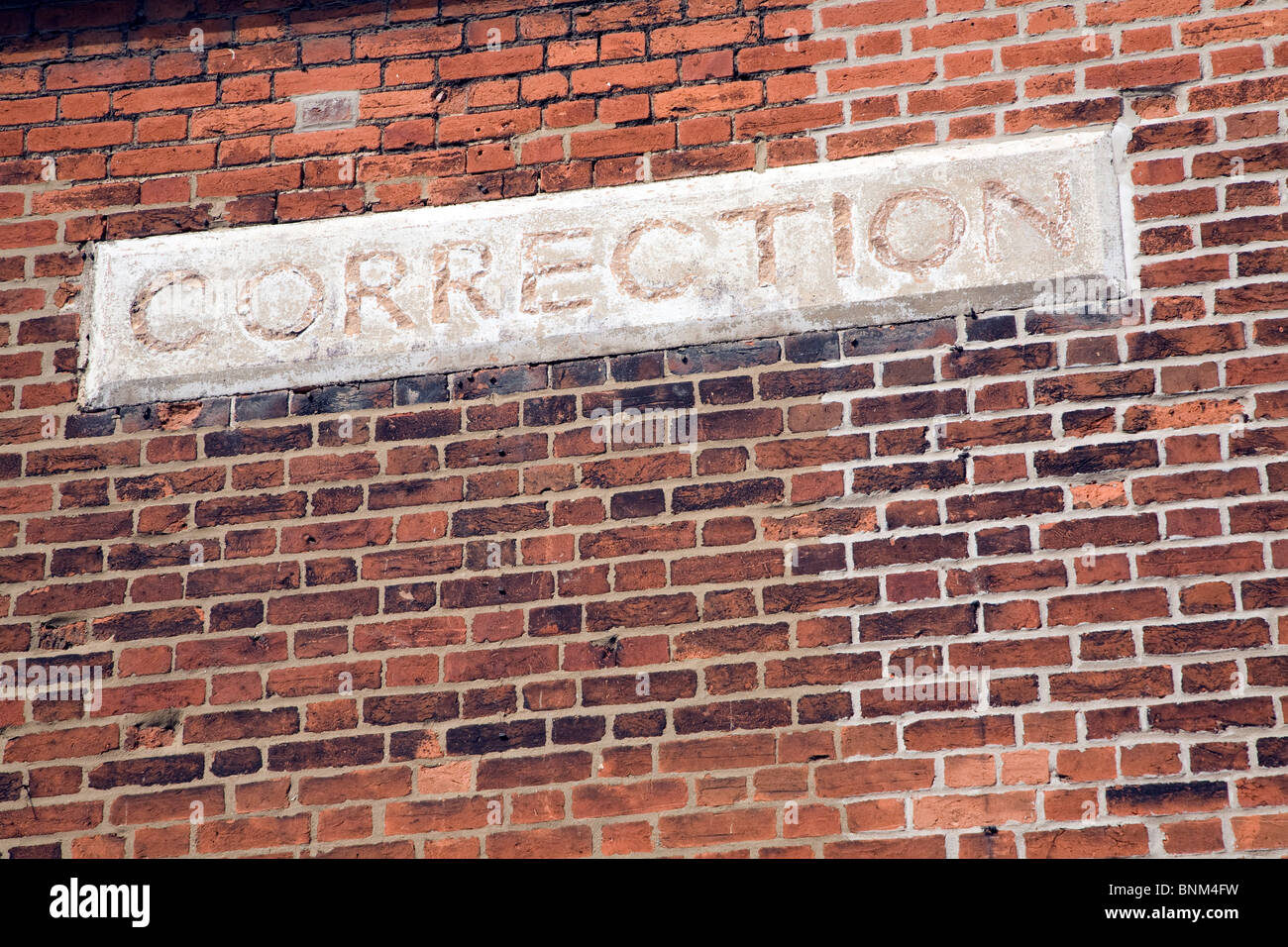 Correction sign in brick wall Stock Photo - Alamy