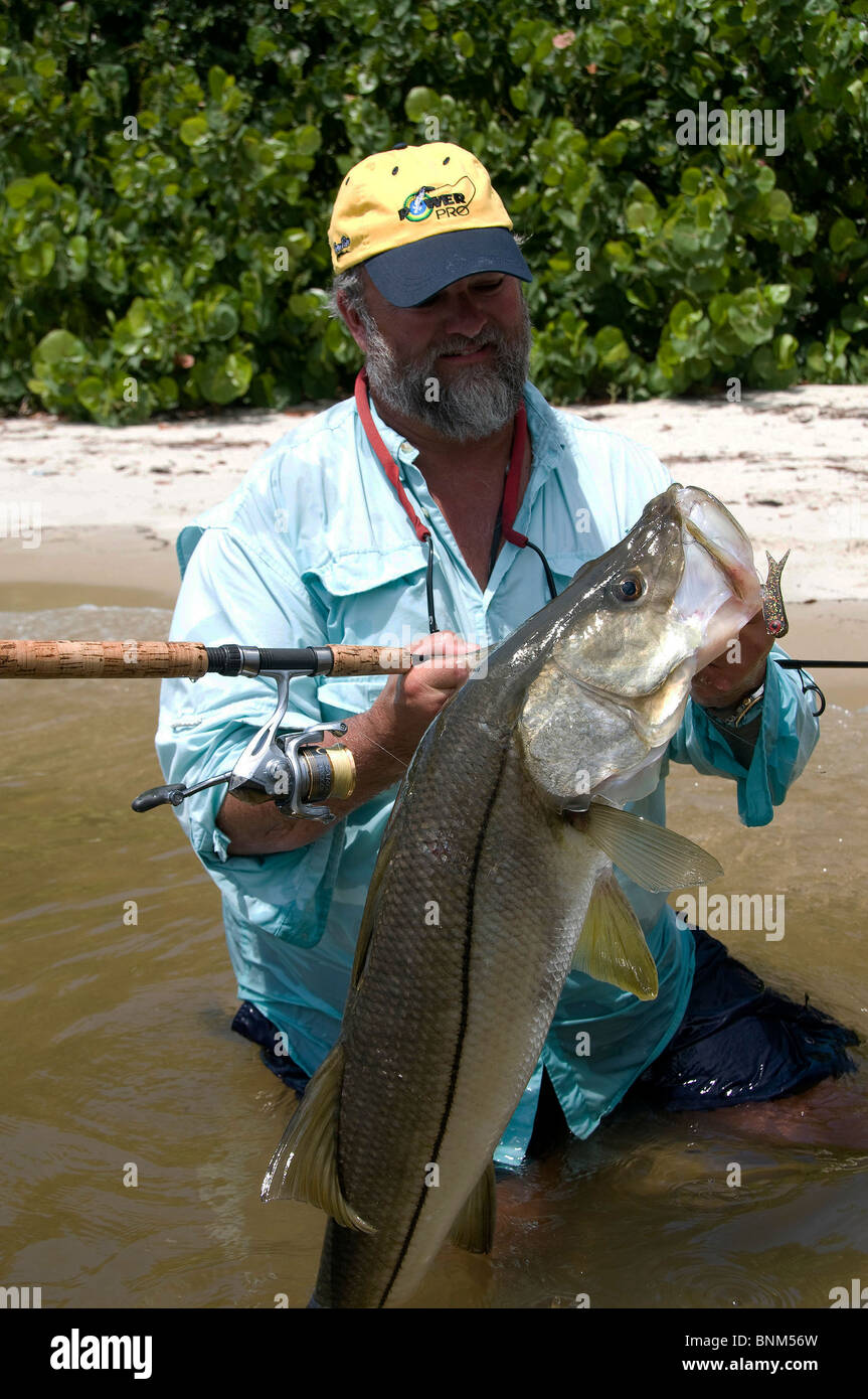An inshore angler hefts a giant snook caught in Florida's Intracoastal ...