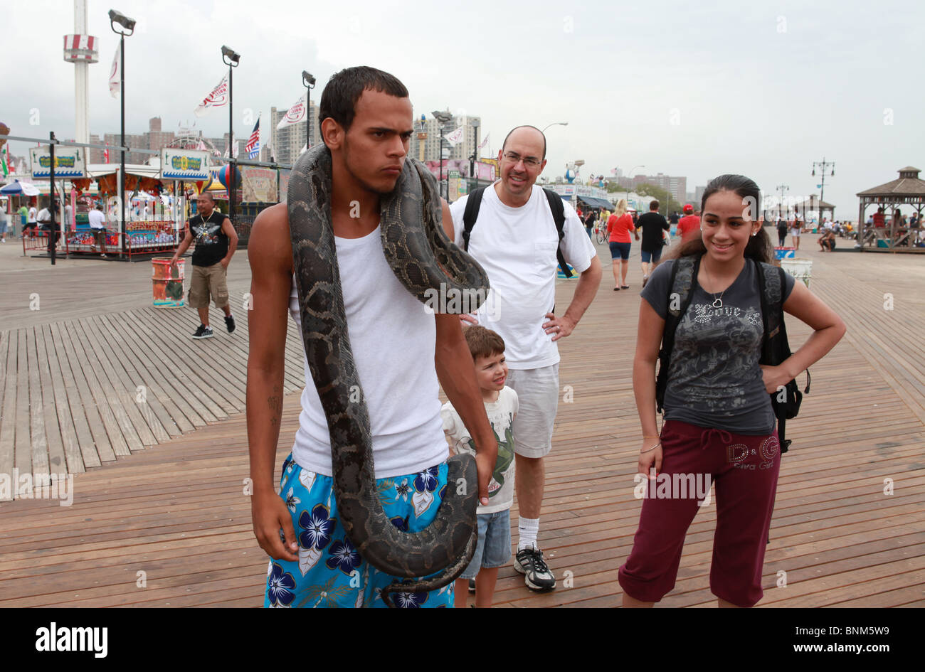 Man with snake on Coney Island boardwalk Stock Photo - Alamy