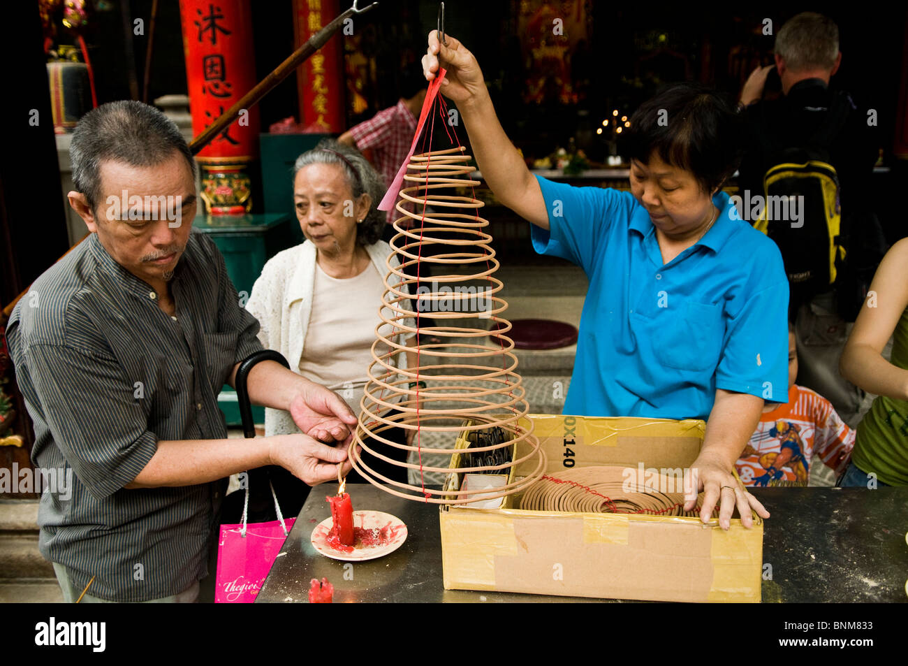 Lighting up a spiral incense stick in a Chinese temple in Saigon Stock ...