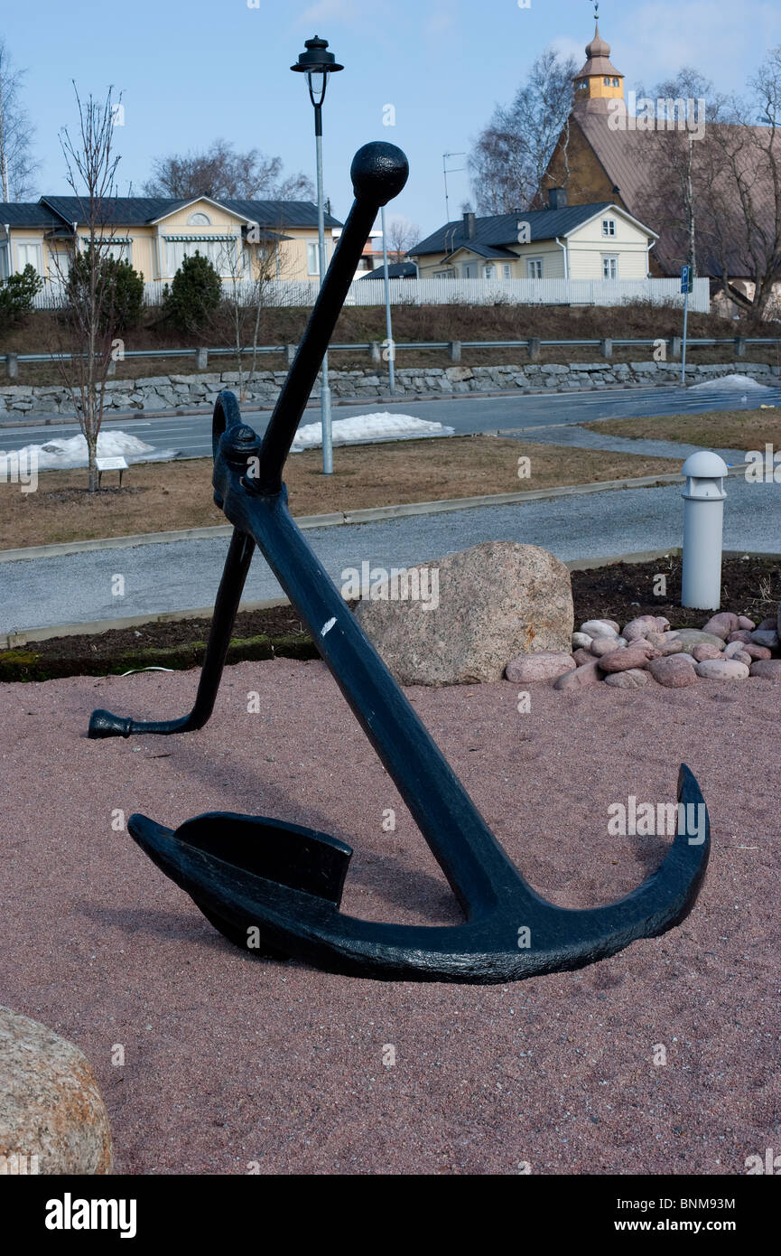 Large black anchor placed on the sidewalk near a busy street as an art ...