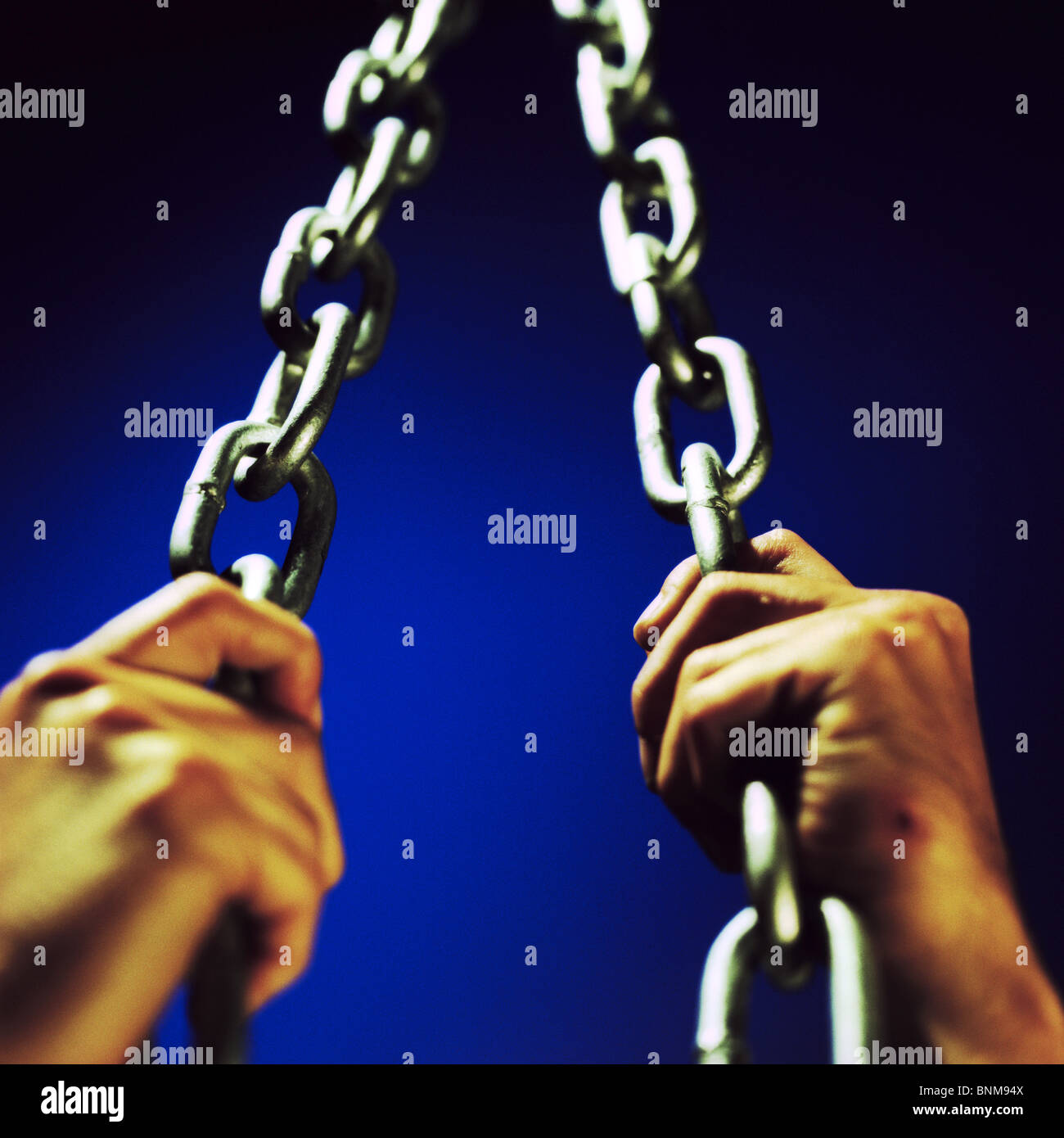 A man's hands gripping a chain Stock Photo - Alamy