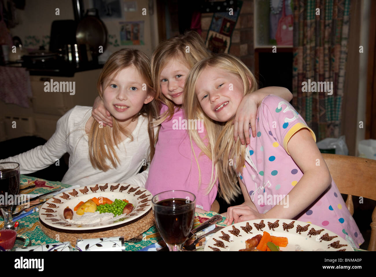 Three happy sisters at dining table Cotswolds UK Stock Photo - Alamy