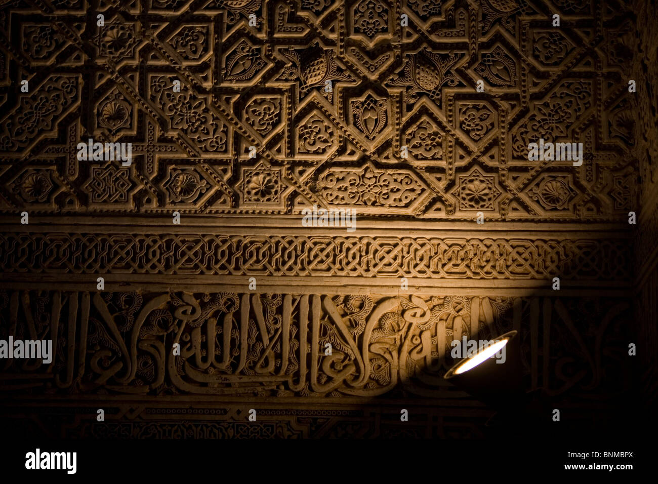 A wall is covered by geometric designs in the Alhambra in Granada ...