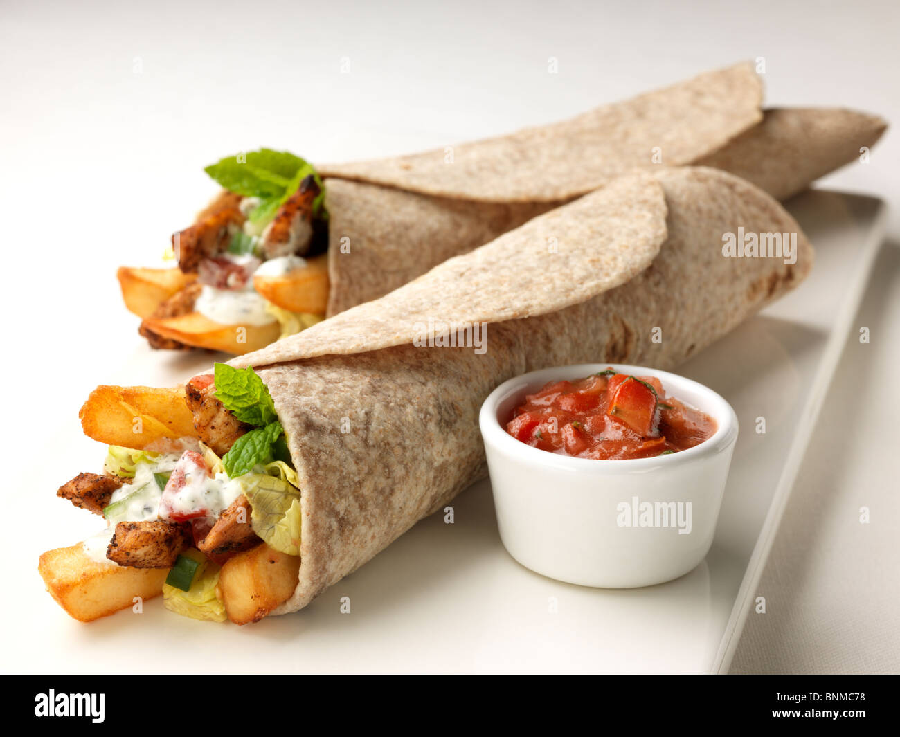 Chicken chapati wraps with chips fusion food Stock Photo - Alamy
