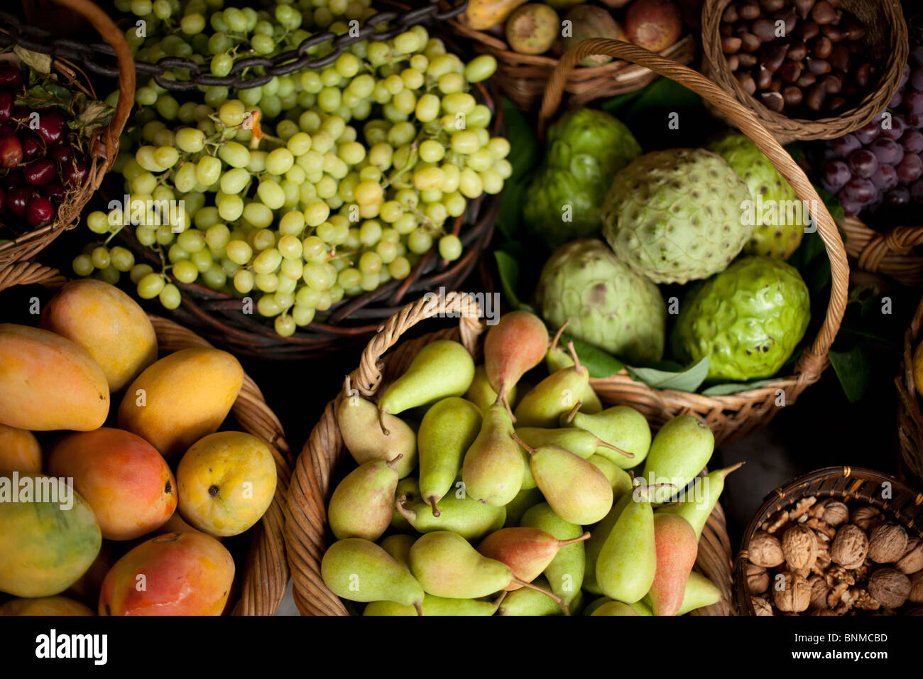 Various fruits and nuts on display in baskets Stock Photo - Alamy