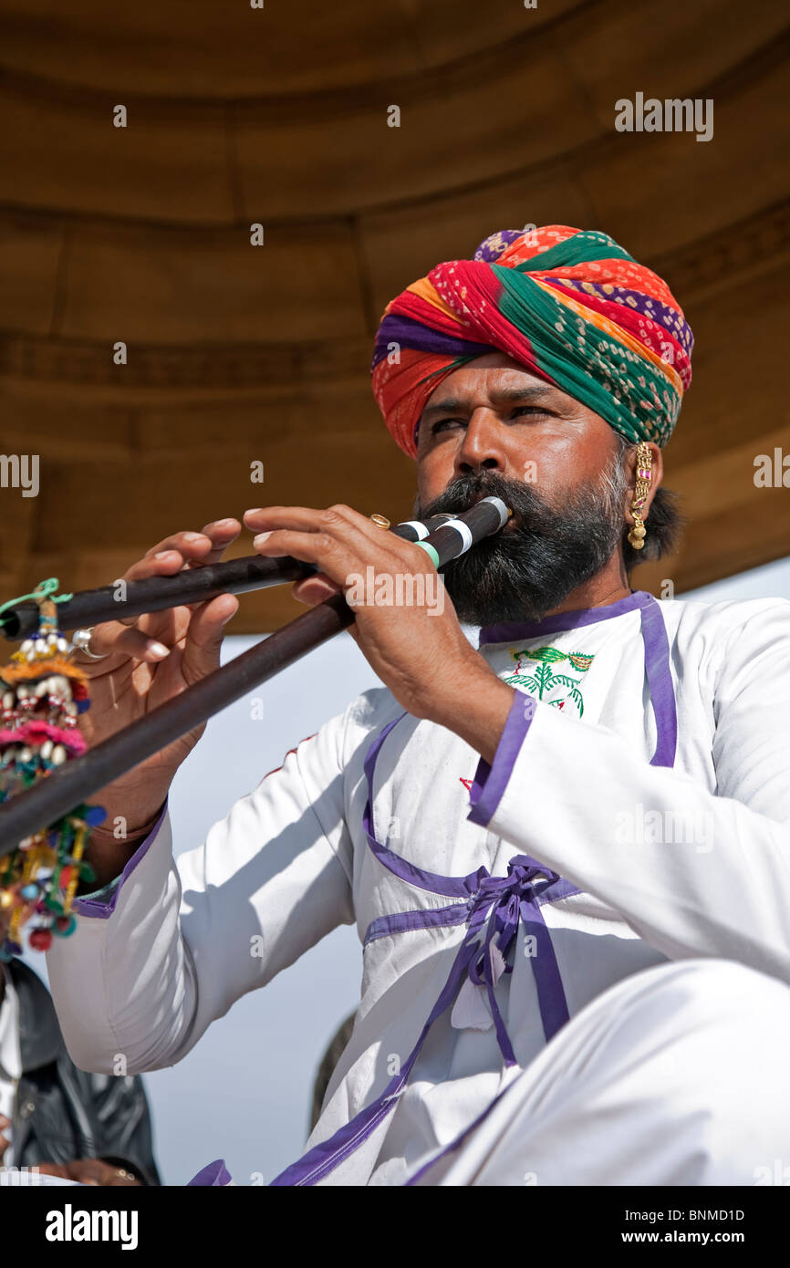 Indian musician playing two flutes. Khuri village. Rajasthan. India ...