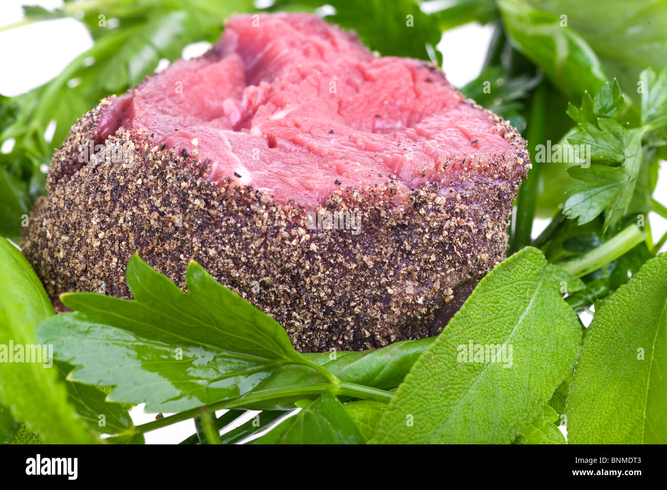 raw fillet steak on mixed herbs Stock Photo - Alamy