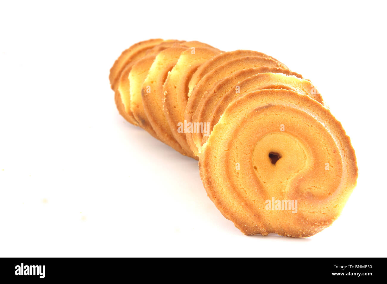 Row of golden shortbread butter biscuits with one facing the camera ...