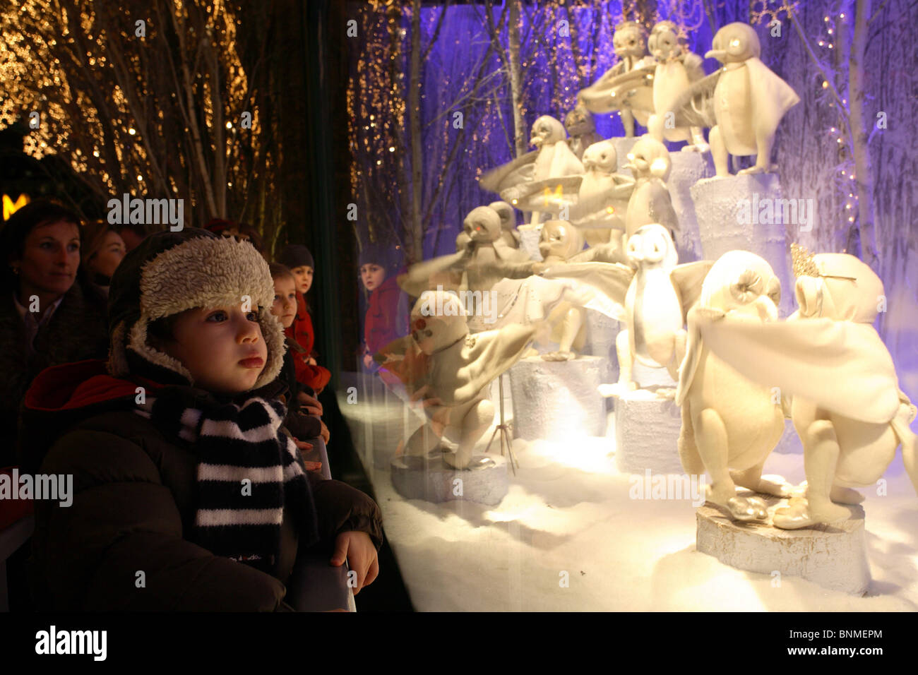 Children gazing at a shop window of Galeries Lafayette department store ...