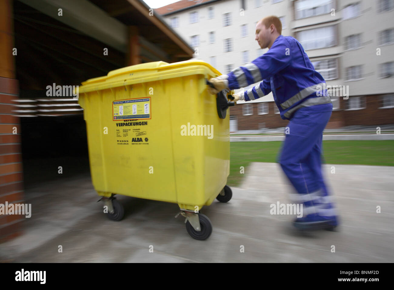 A young trainee pushing a garbage bin, Berlin, Germany Stock Photo - Alamy