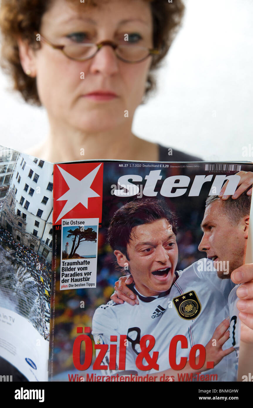 German woman reading weekly news and events magazine Stern Stock Photo ...