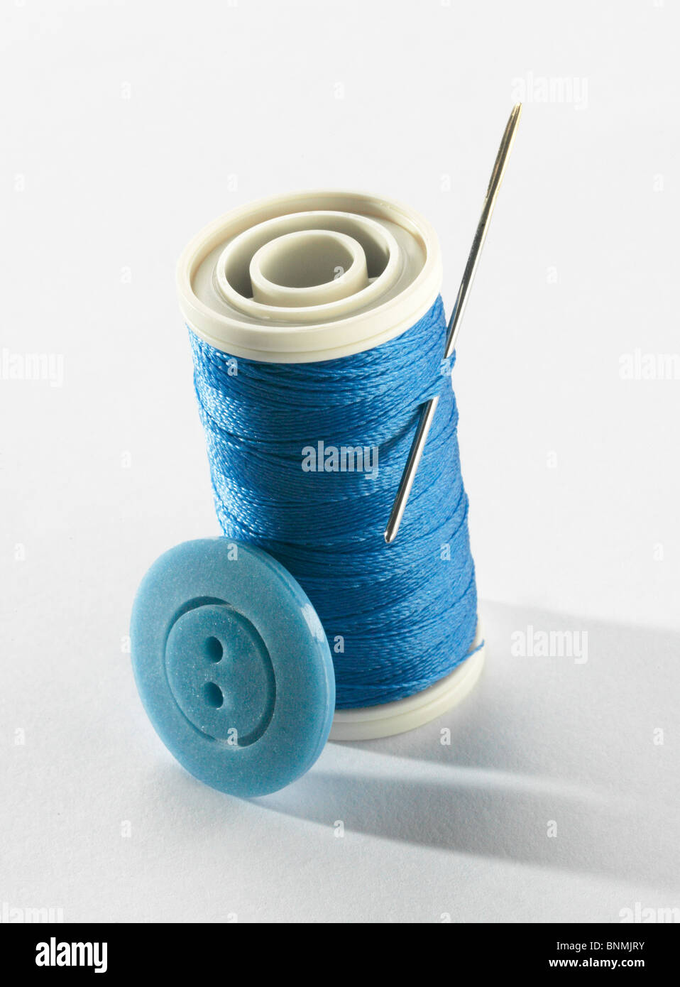 Blue thread,needle,blue button Stock Photo - Alamy