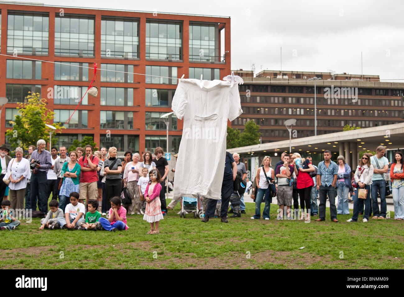 White dress hanging from above grass a line in an urban environment ...