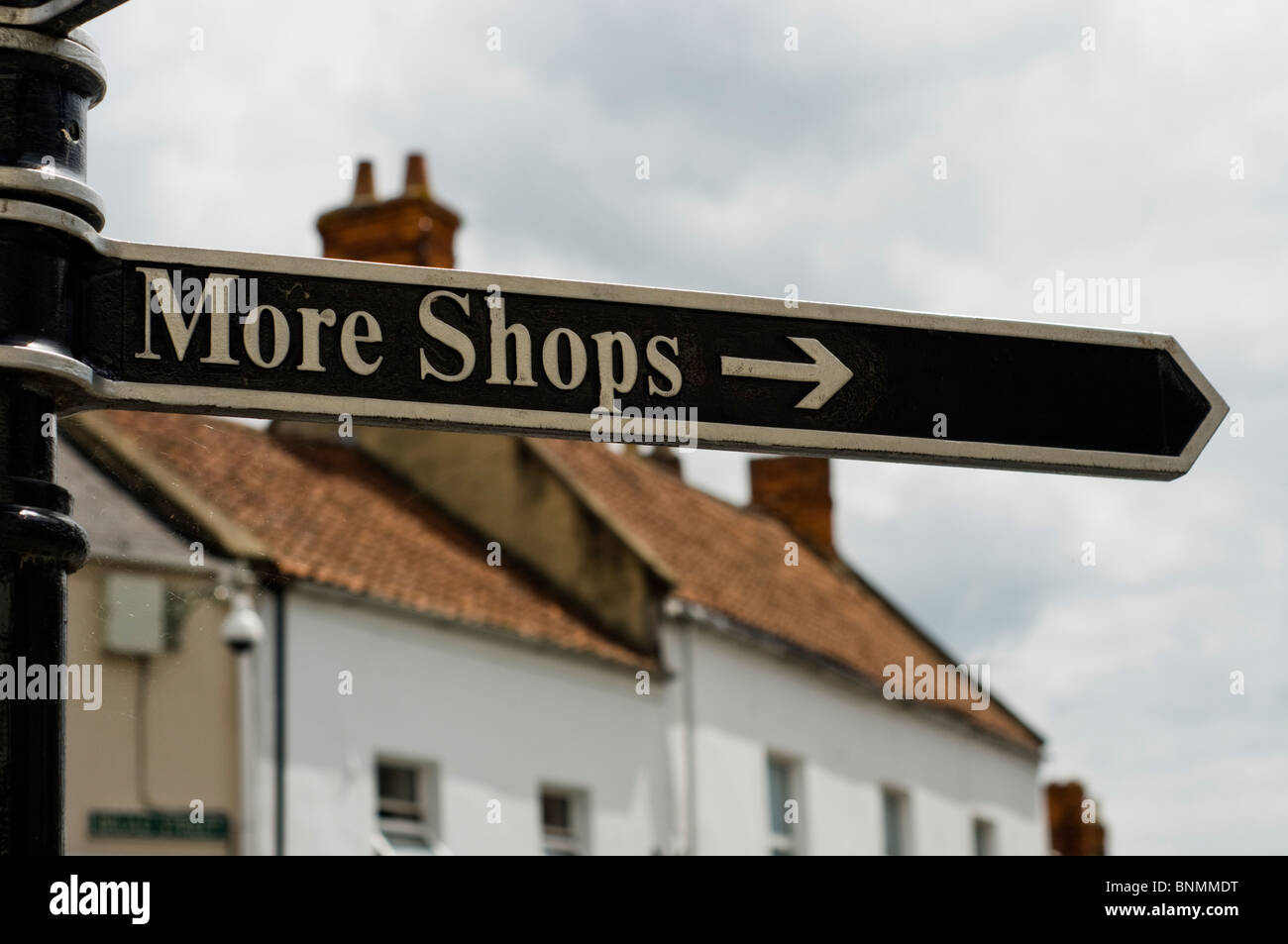 Sign post to the shops Stock Photo - Alamy