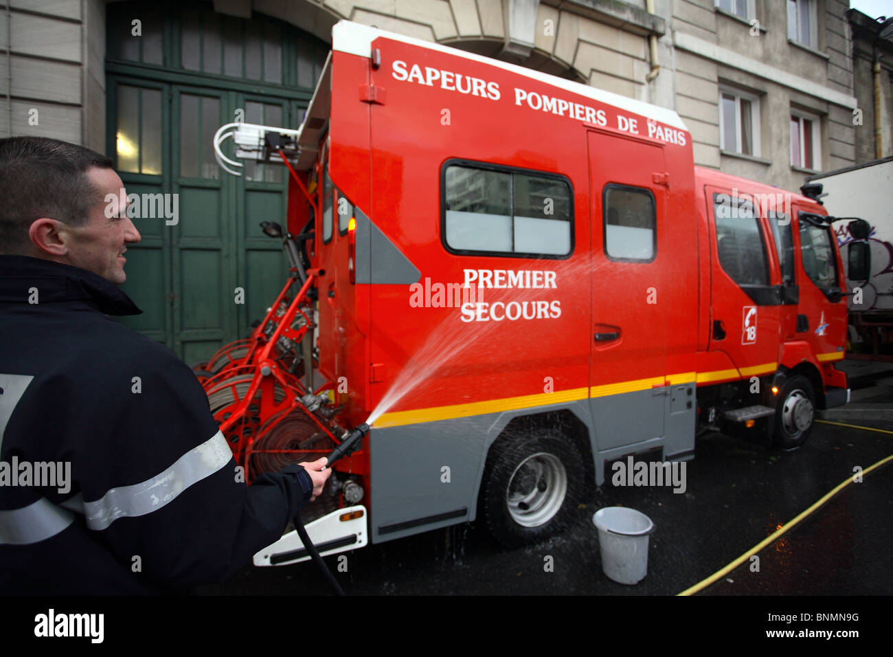 Firefighter washing a fire engine, Paris, France Stock Photo - Alamy