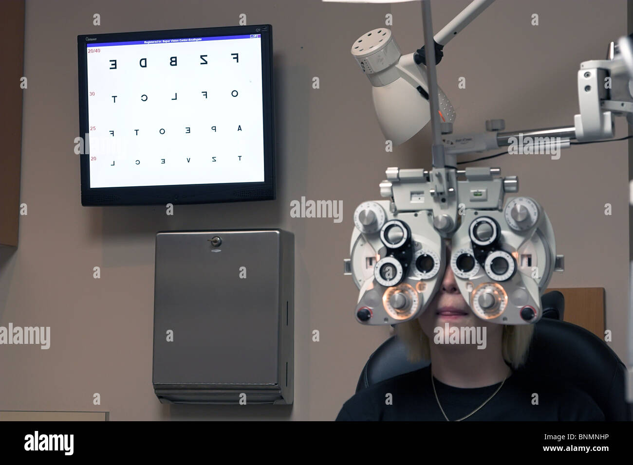 A woman getting an eye exam using newer digital technology Stock Photo ...