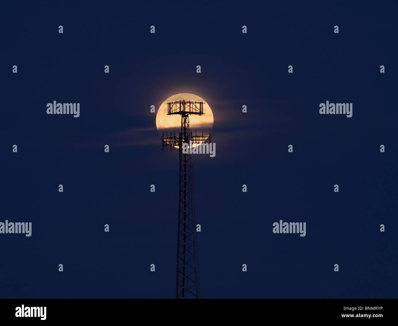 Full Moon behind and silhouetting cell phone tower Stock Photo - Alamy