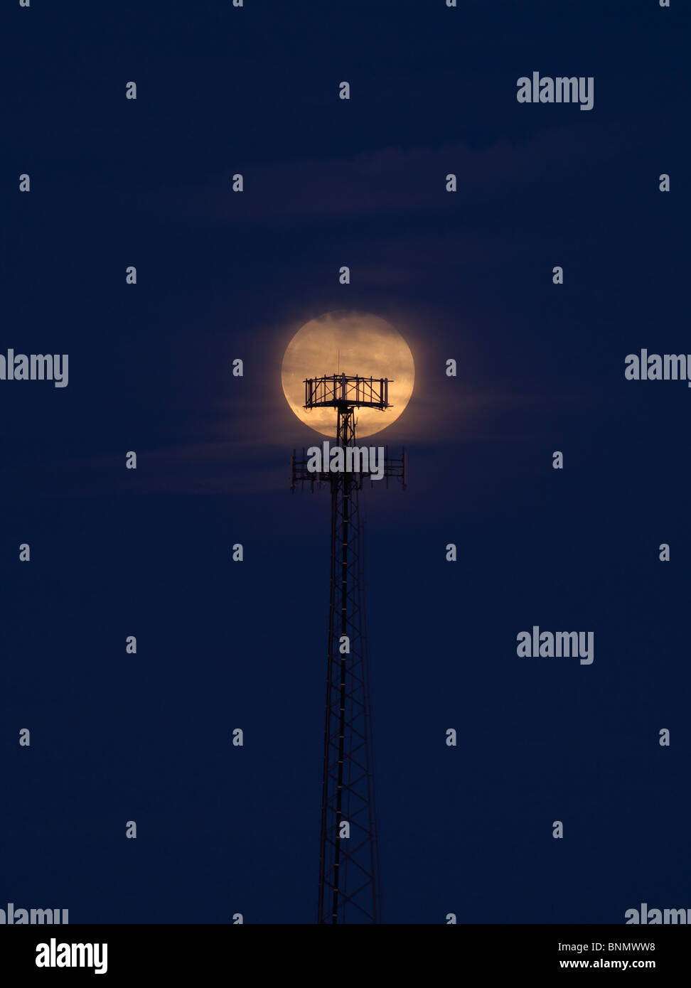 Full Moon behind and silhouetting cell phone tower Stock Photo - Alamy