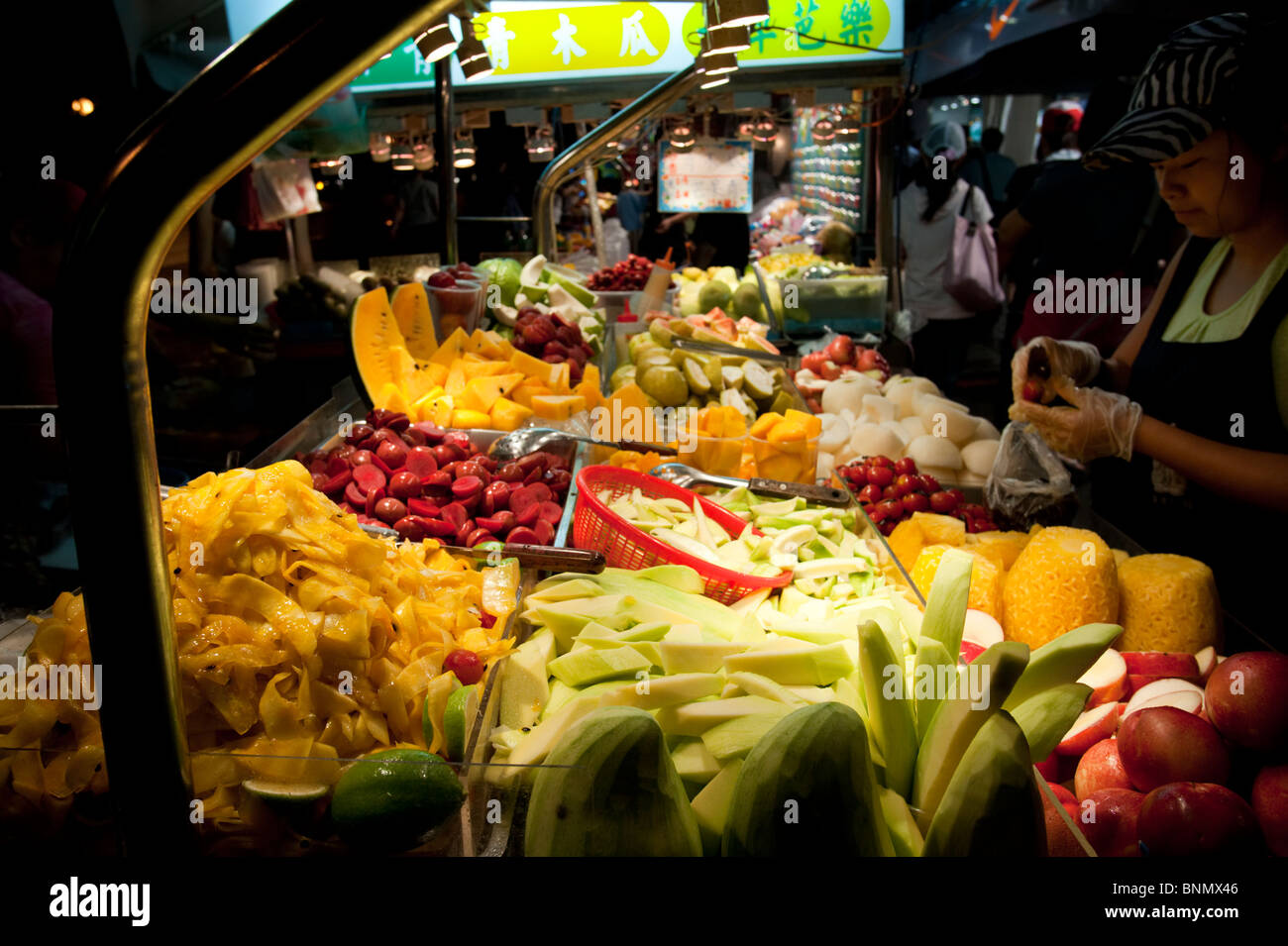 A stand selling a wide variety of fruit and berries displays its wares ...